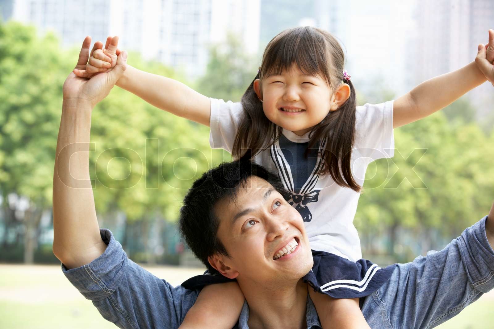 Chinese Father Giving Daughter Ride On Shoulders In Park | Stock image ...