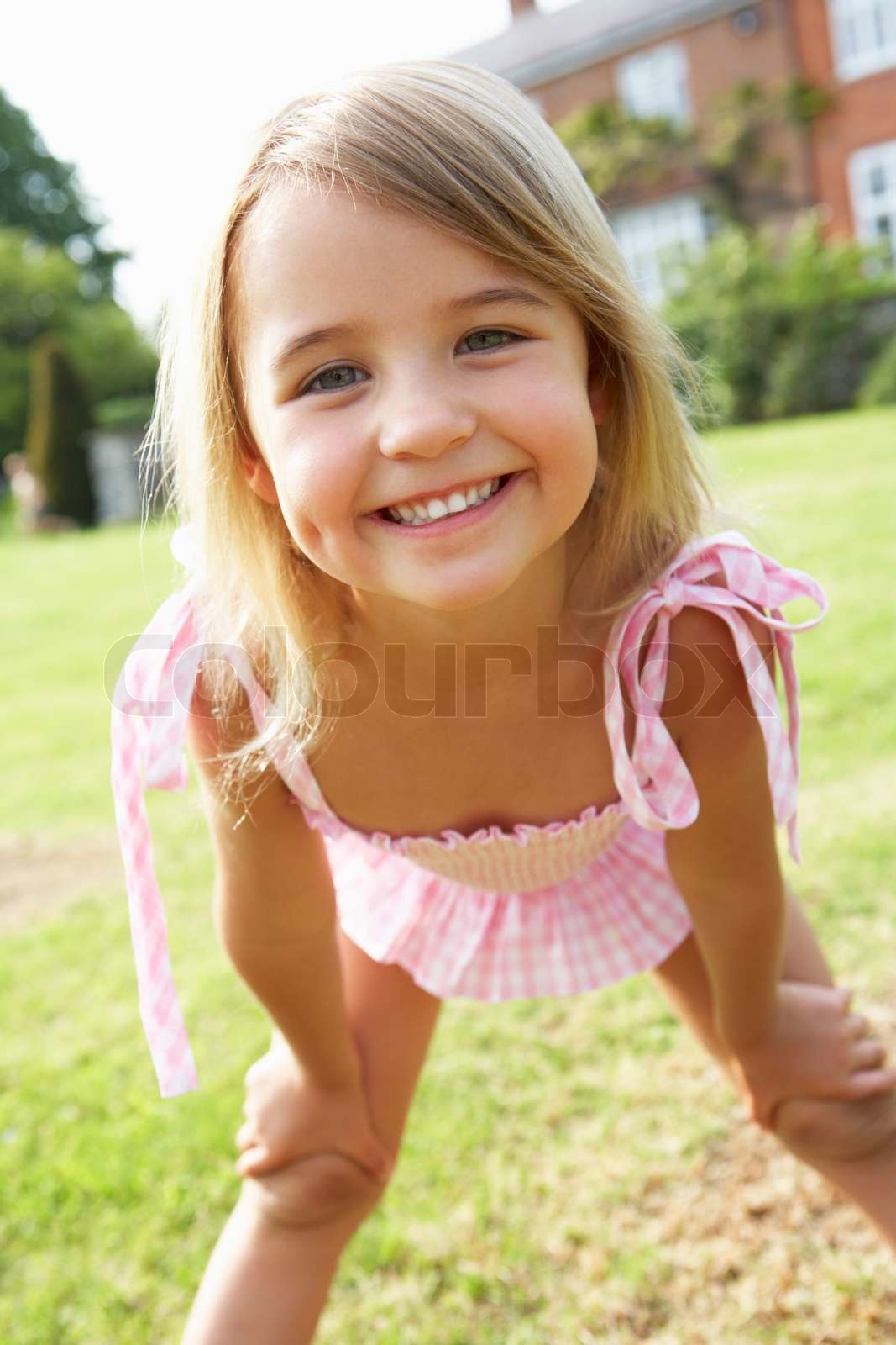 Portrait Of Young Girl Standing In Garden Tragen Swimming Costume
