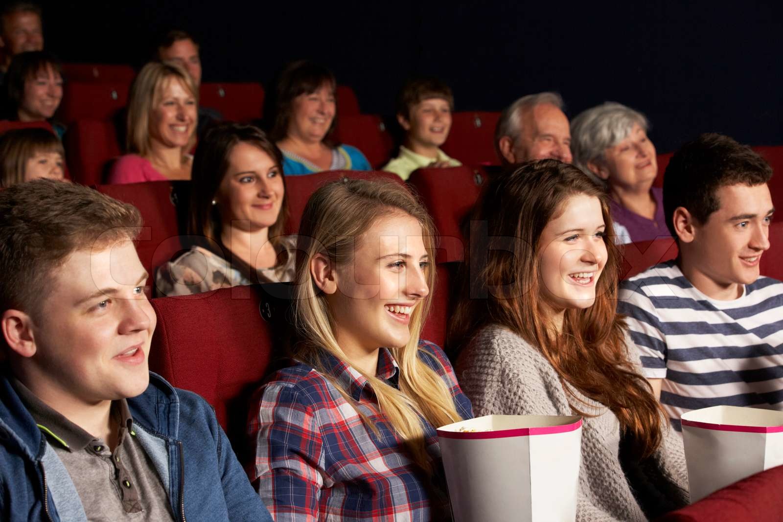 Group Of Teenage Friends Watching Film In Cinema | Stock image | Colourbox
