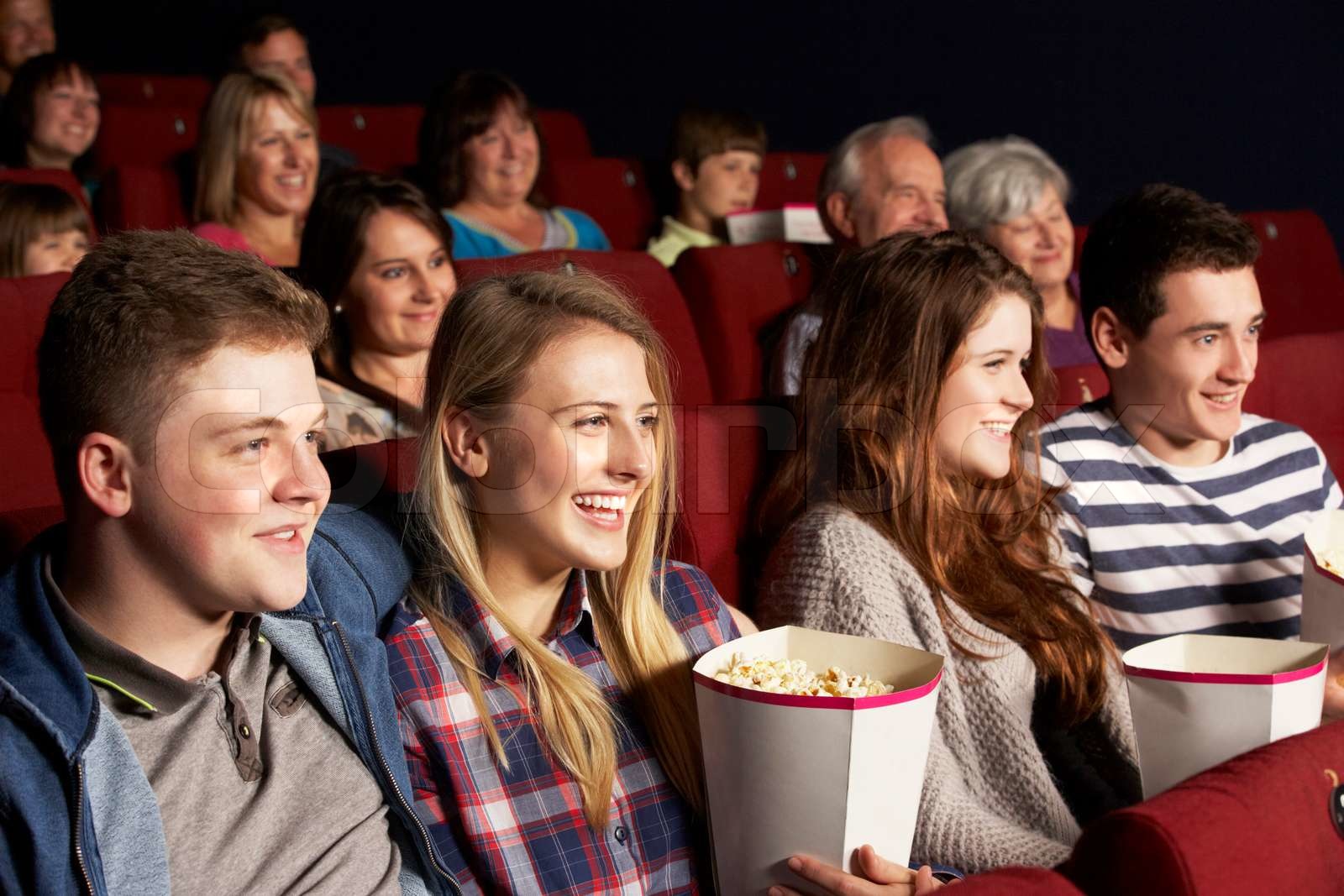 Group Of Teenage Friends Watching Film In Cinema | Stock image | Colourbox