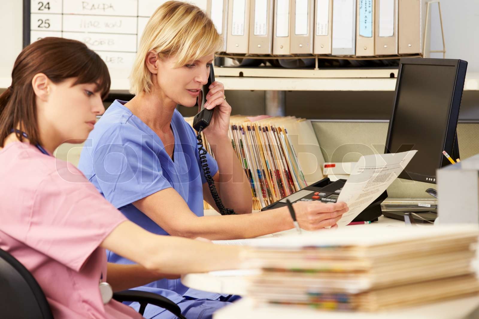 Two Nurses Working At Nurses Station | Stock image | Colourbox