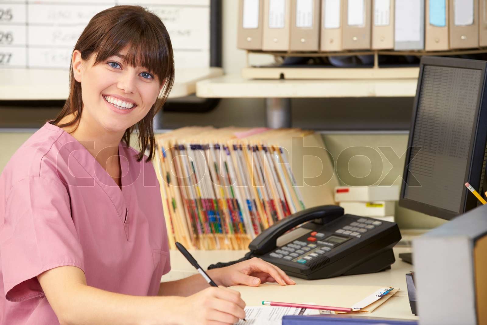 Nurse Working At Nurses Station | Stock image | Colourbox