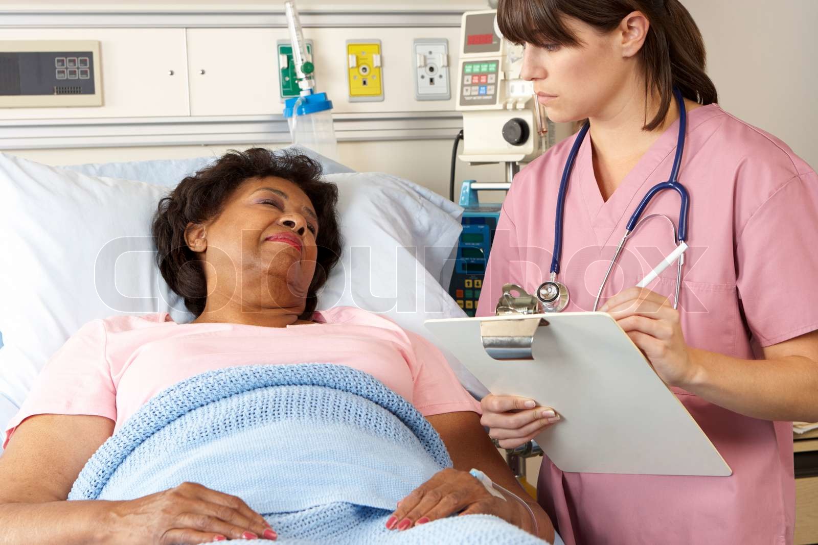Nurse Visiting Senior Female Patient On Ward | Stock image | Colourbox