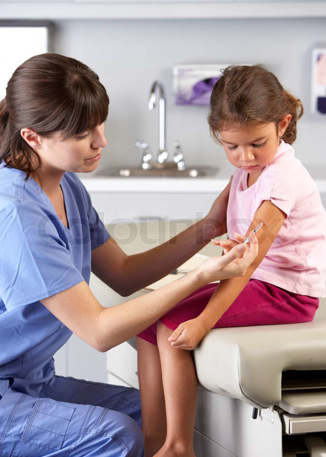 Doctor Giving Child Injection In Doctor's Office | Stock image | Colourbox