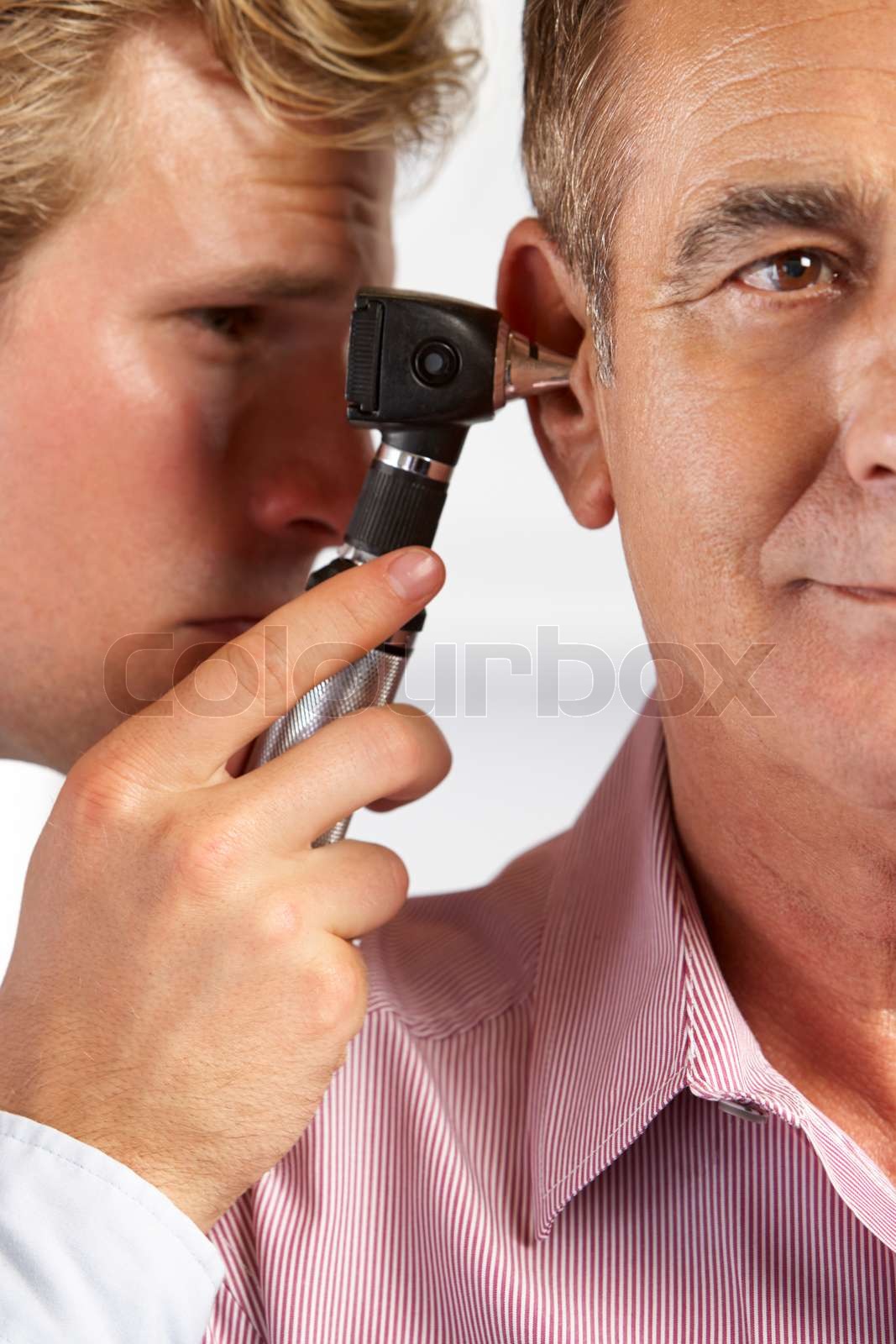 Doctor Examining Male Patient's Ears | Stock image | Colourbox