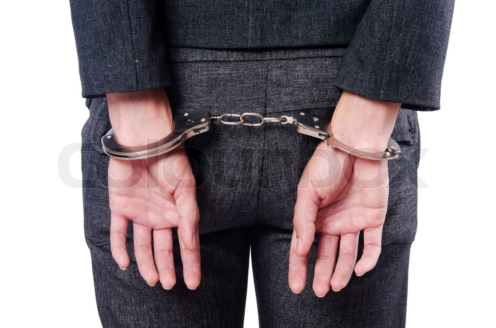 Weibliche Geschäftsfrau mit Handschellen auf weiß | Stock Bild | Colourbox