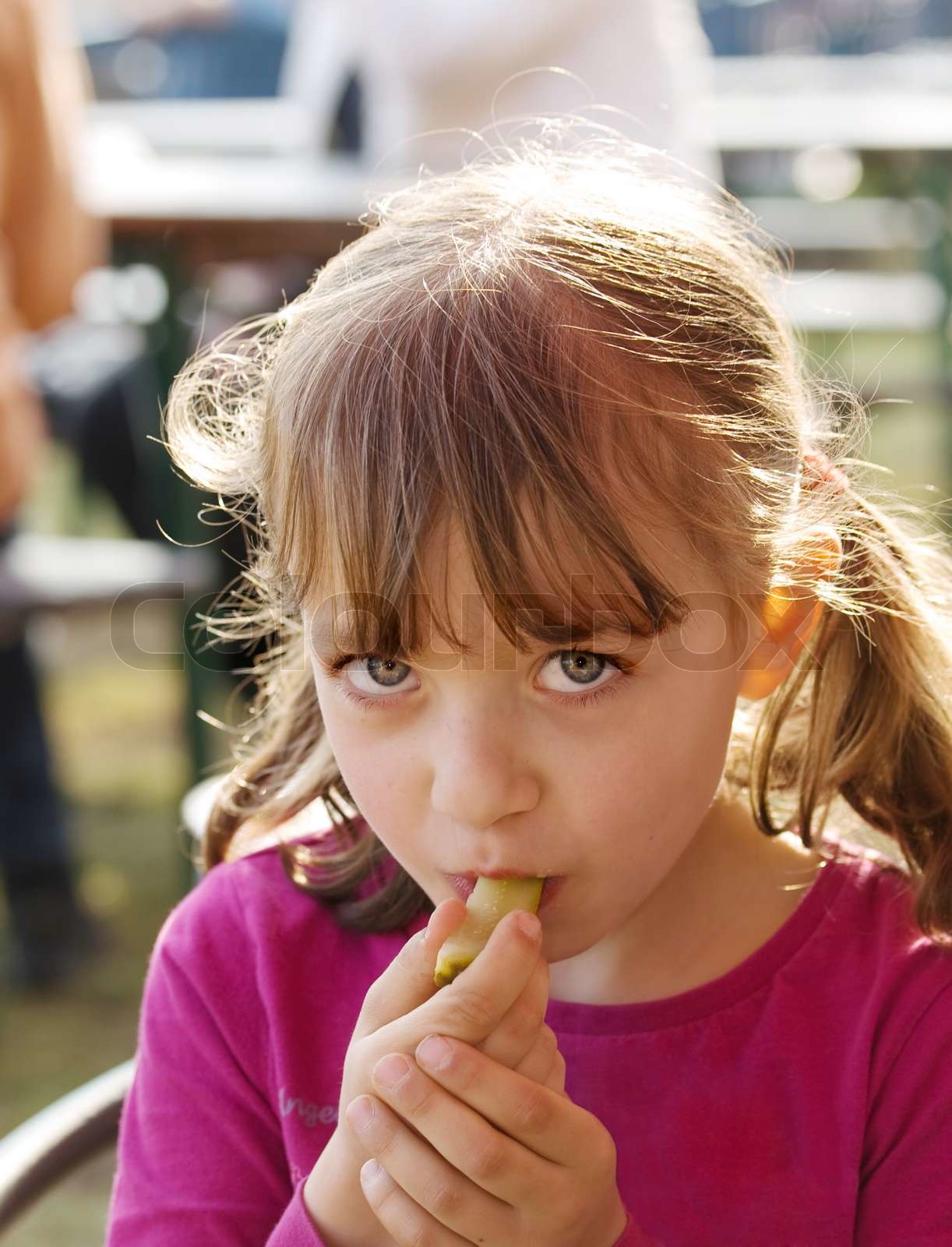 Girl having snack | Stock image | Colourbox