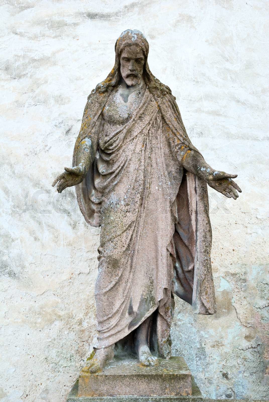Old statue of Jesus Christ with a grungy wall behind | Stock image ...