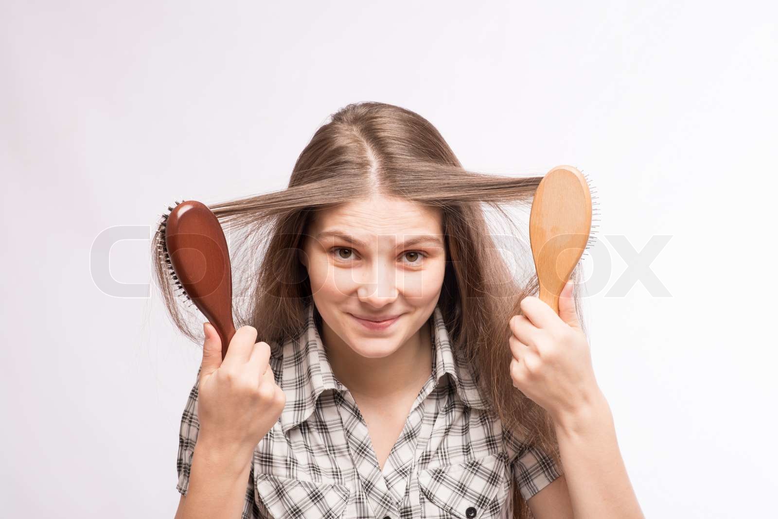 Woman combs her hair | Stock image | Colourbox