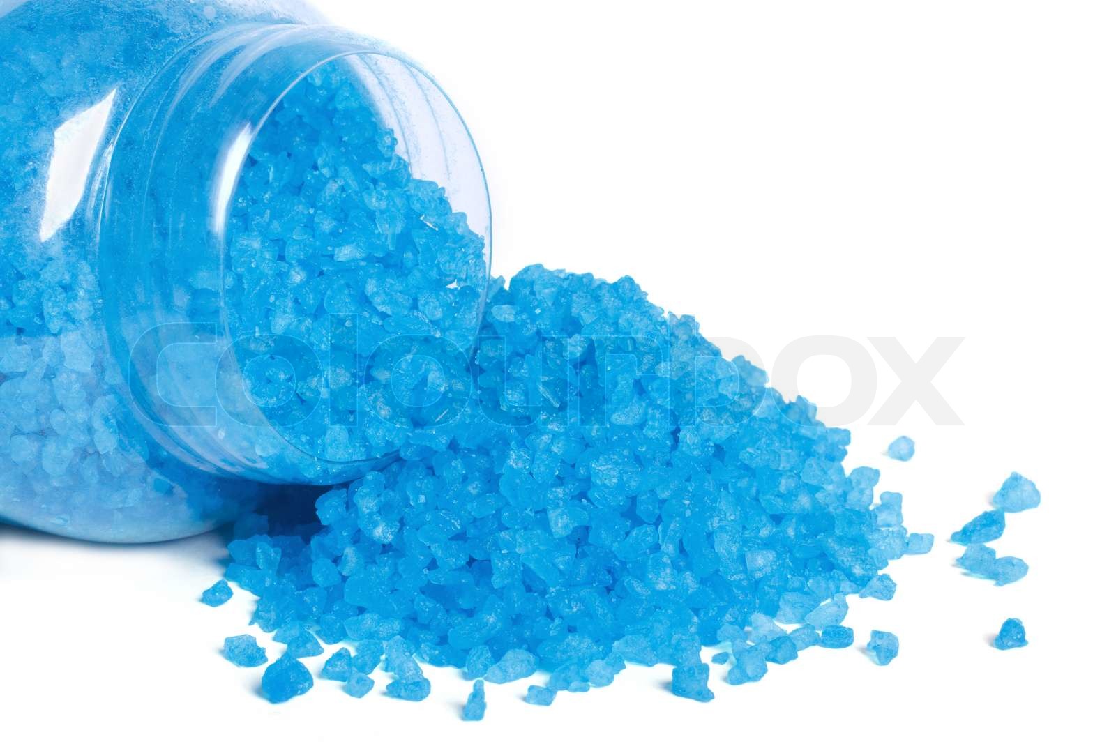 Blue bath salt spilled out of a glass jar isolated on white | Stock ...