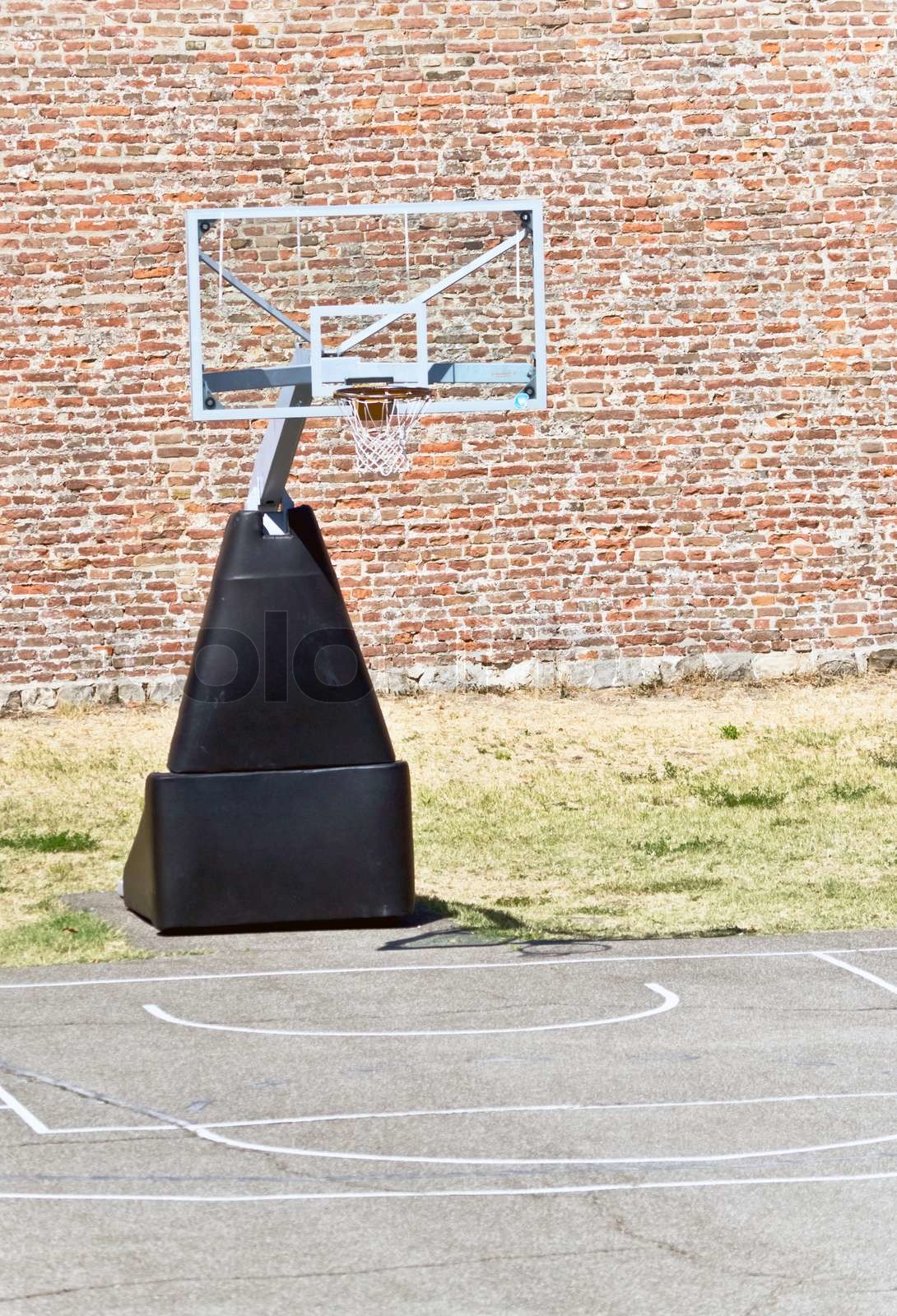 Basketball hoop and an empty outdoor court | Stock image | Colourbox