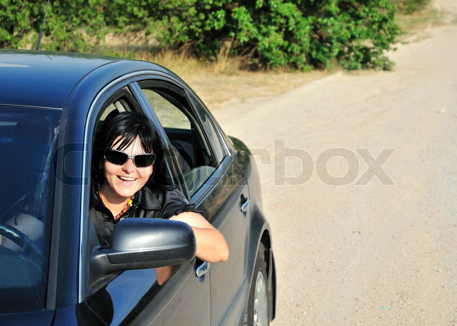 happy girl drive her car in the countryside | Stock image | Colourbox