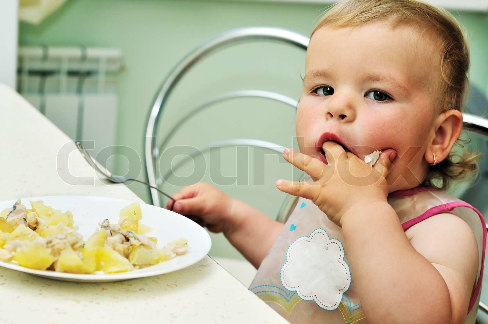 baby girl eating | Stock image | Colourbox