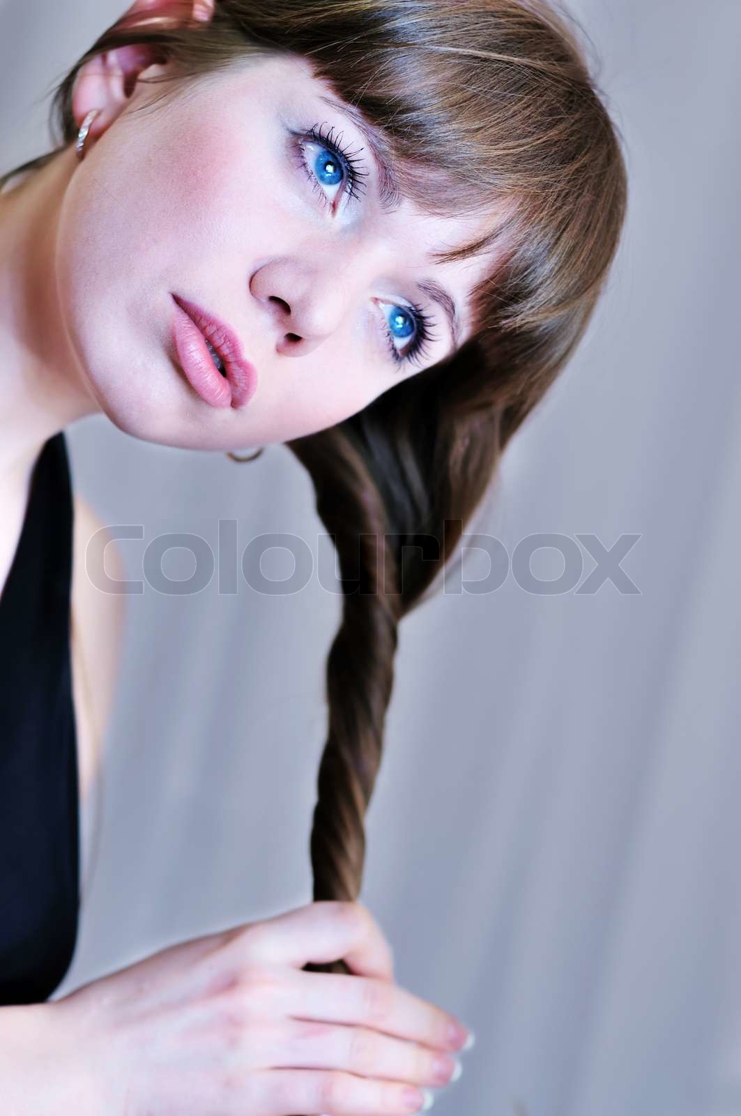 girl twisting hair | Stock image | Colourbox