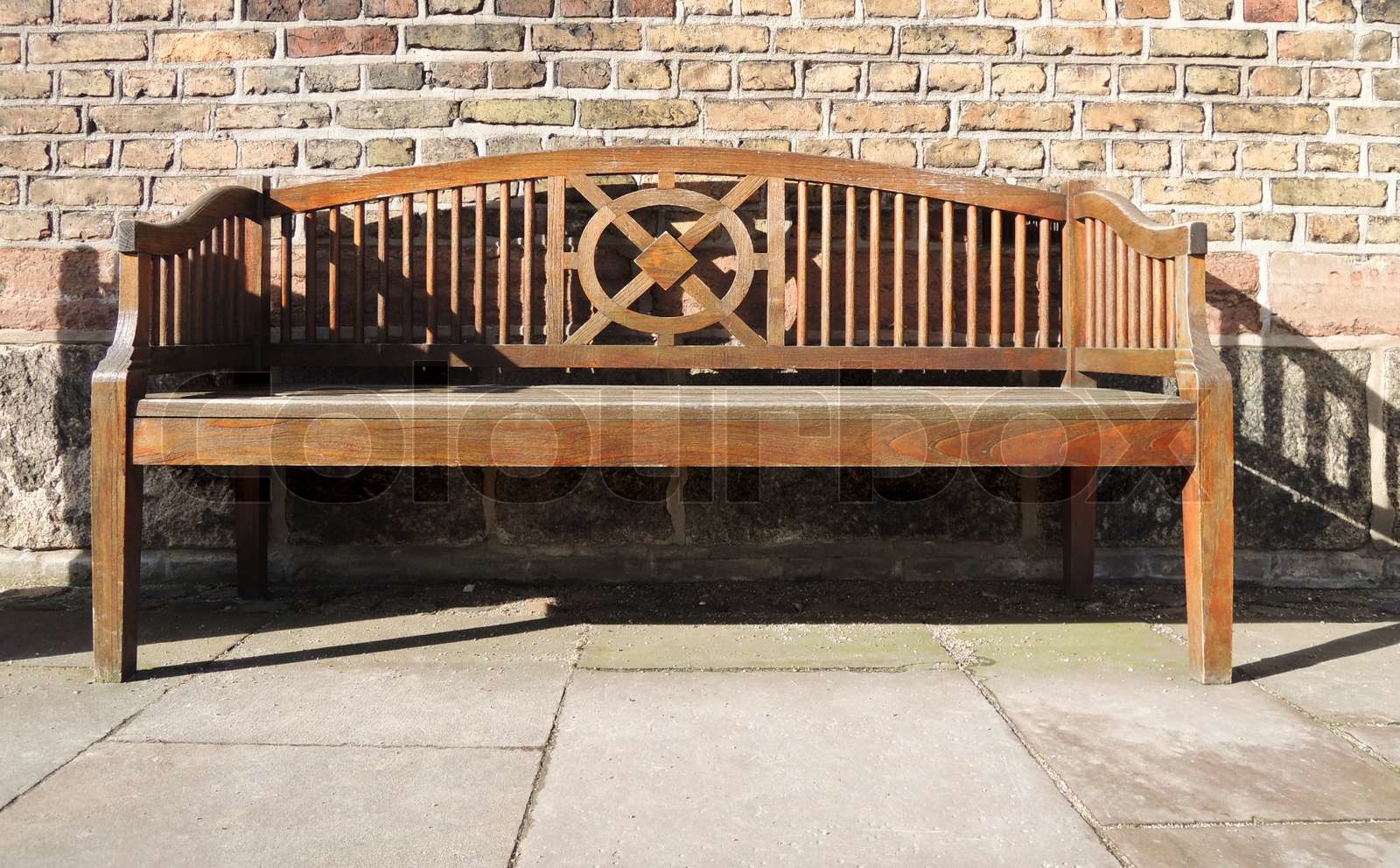 wooden bench on a wall of brick | Stock image | Colourbox