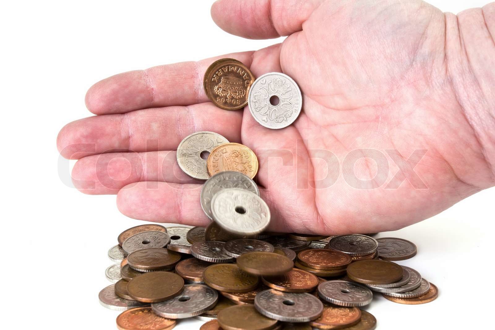 Hand dropping coins | Stock image | Colourbox