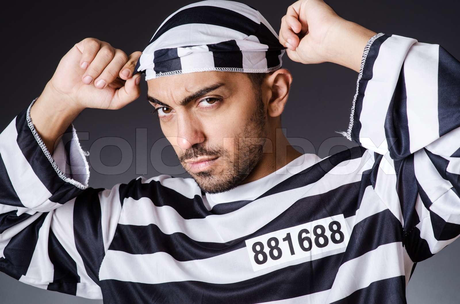 Convict criminal in striped uniform | Stock image | Colourbox