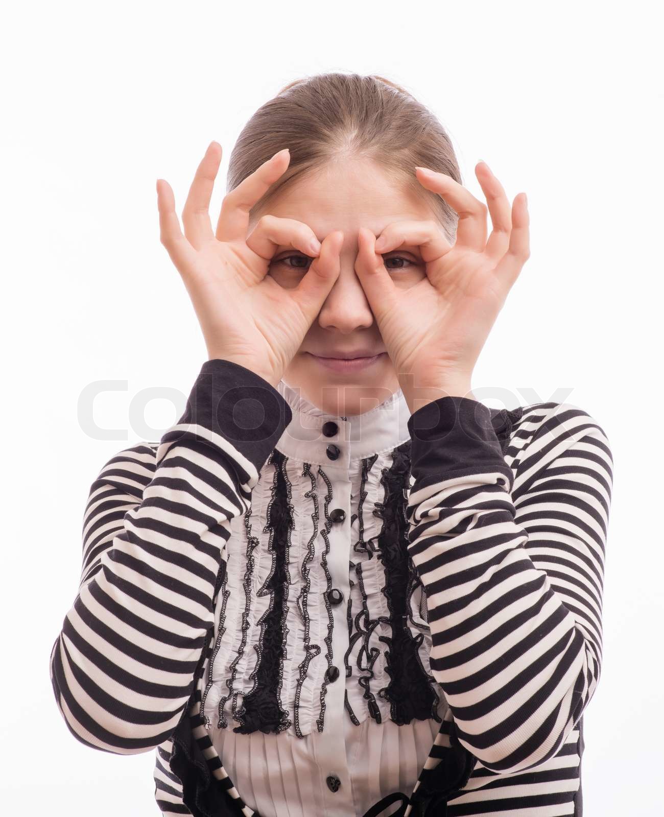 Woman Peaking Through Hands on her face | Stock image | Colourbox