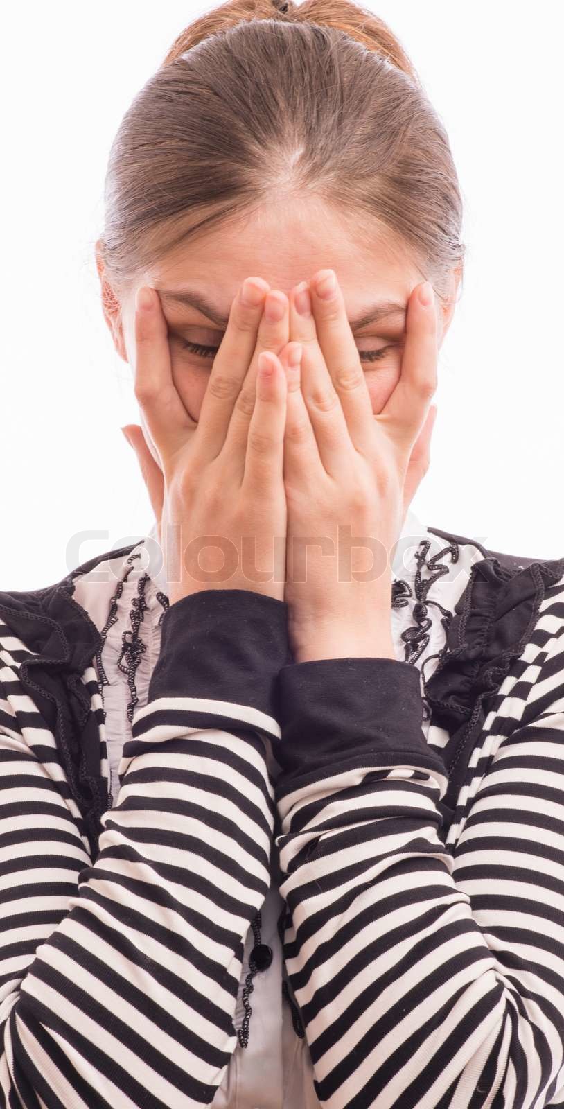Woman Peaking Through Hands on her face | Stock image | Colourbox