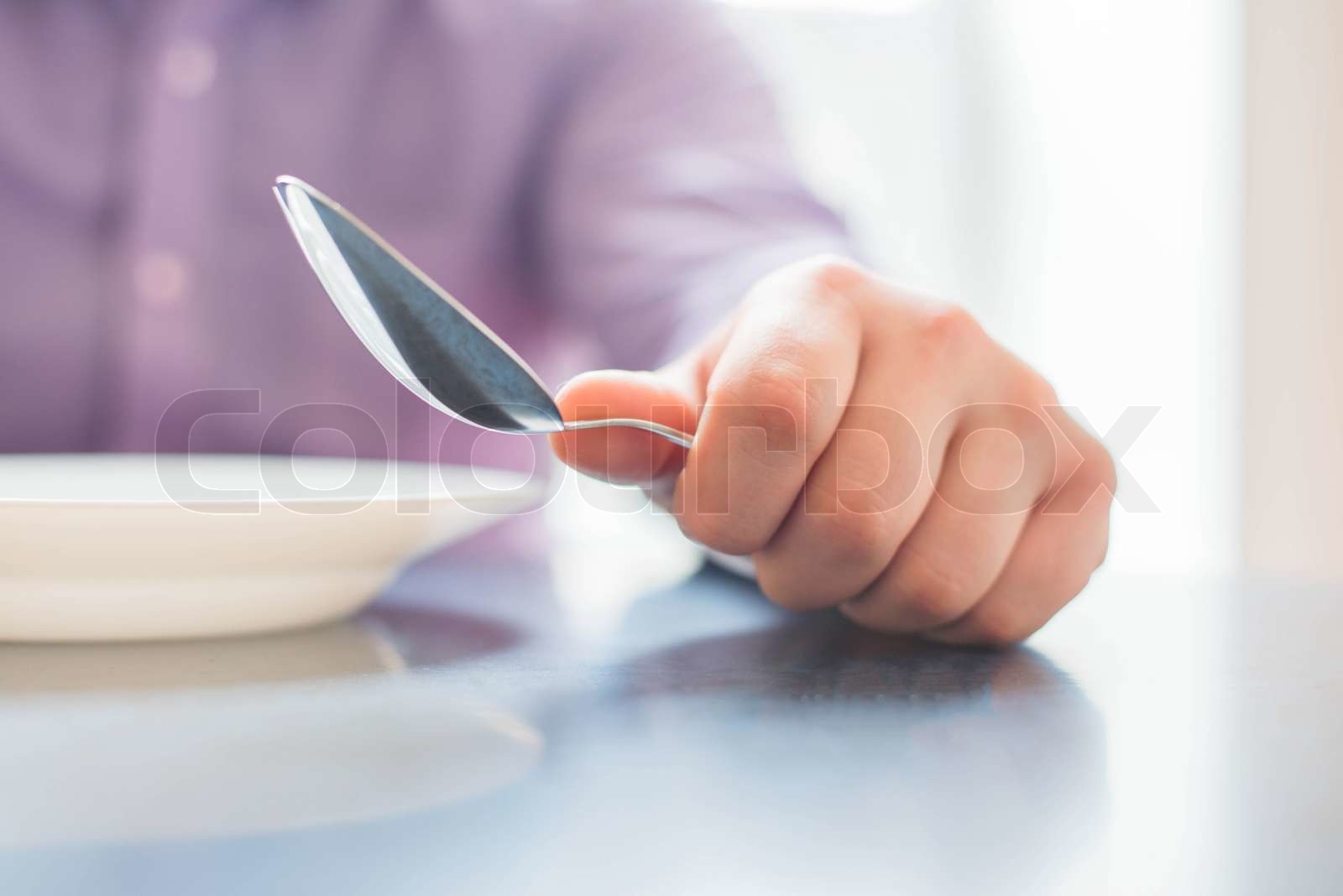 Man sitting at the kitchen table | Stock image | Colourbox