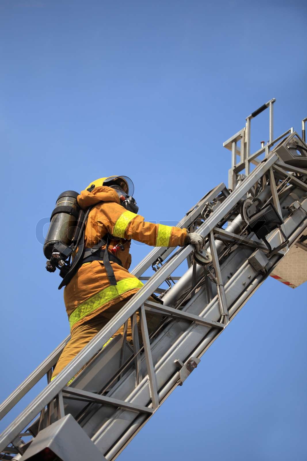 Firefighter ascends upon a one hundred foot ladder | Stock image ...