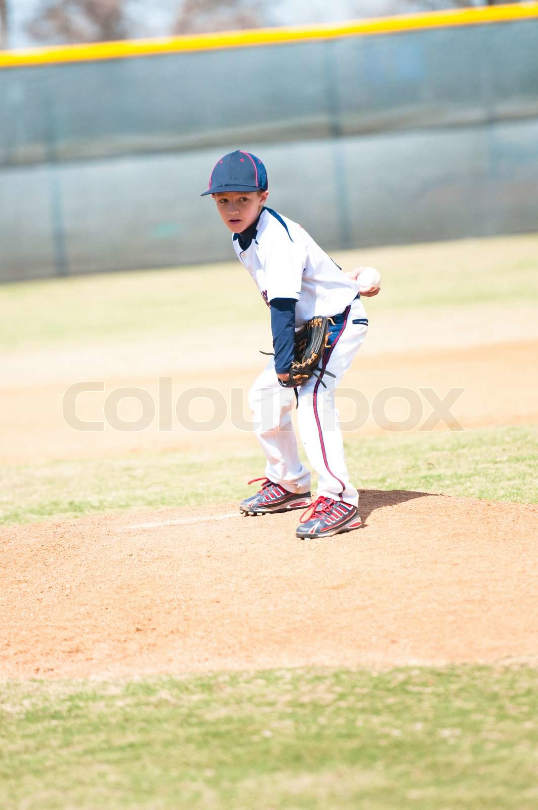 Youth baseball pitcher looking | Stock image | Colourbox