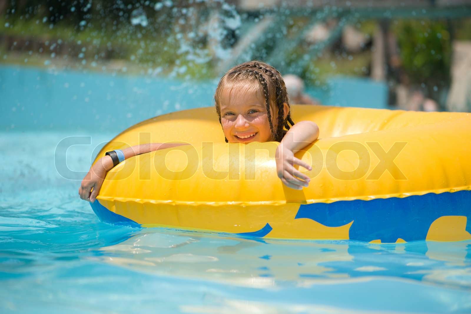 Little girl sitting on inflatable ring | Stock image | Colourbox