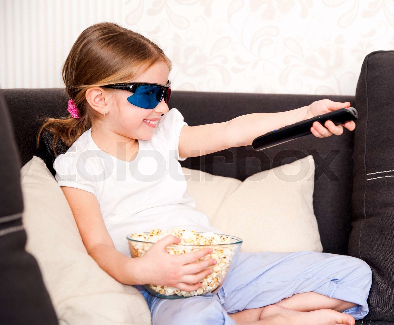 little girl watching TV | Stock image | Colourbox