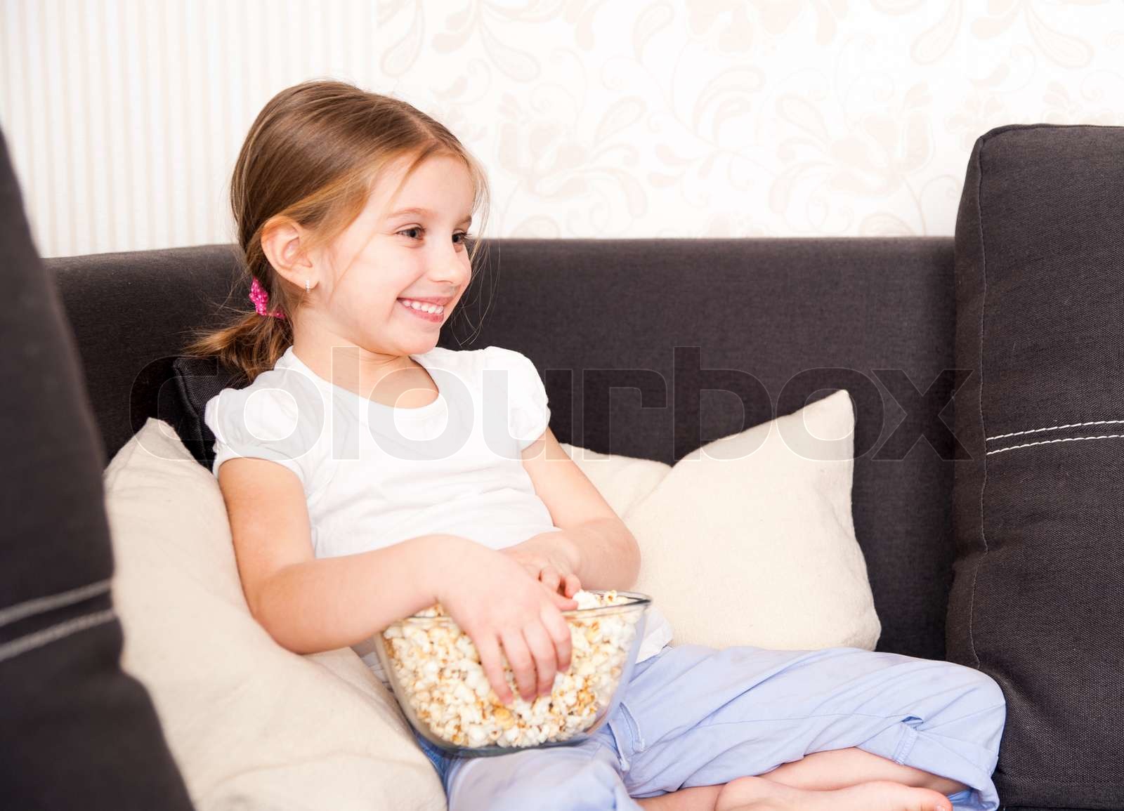 little girl watching TV | Stock image | Colourbox