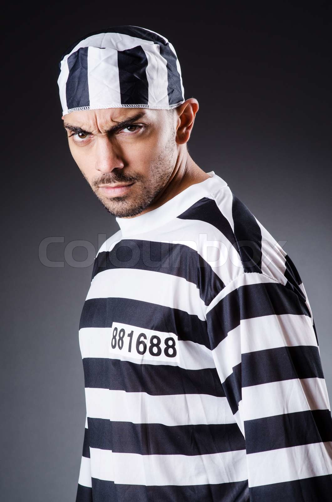 Convict criminal in striped uniform | Stock image | Colourbox