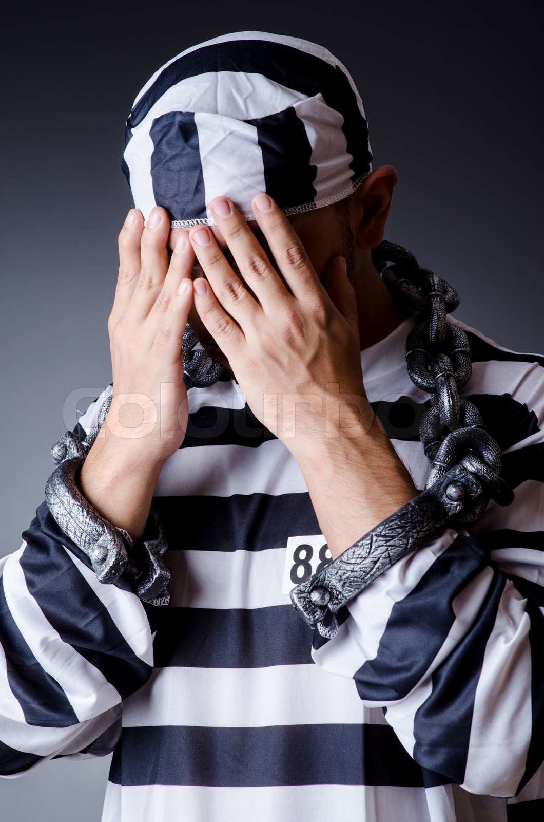 Convict criminal in striped uniform | Stock image | Colourbox