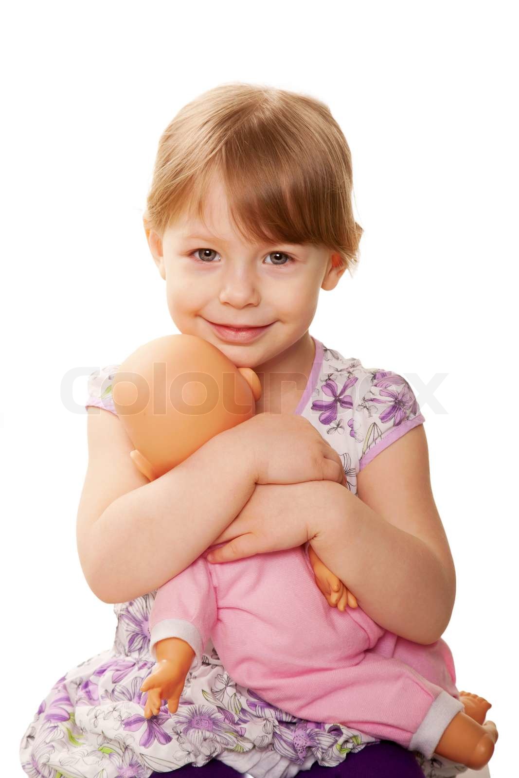 Little girl hugging doll Nursing concept | Stock image | Colourbox