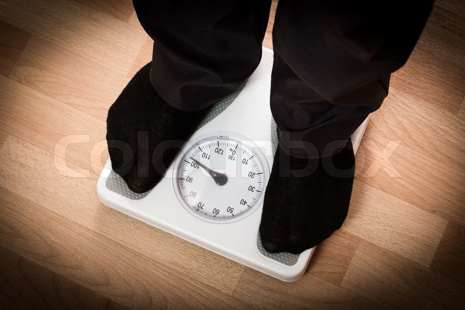 man on scales | Stock image | Colourbox