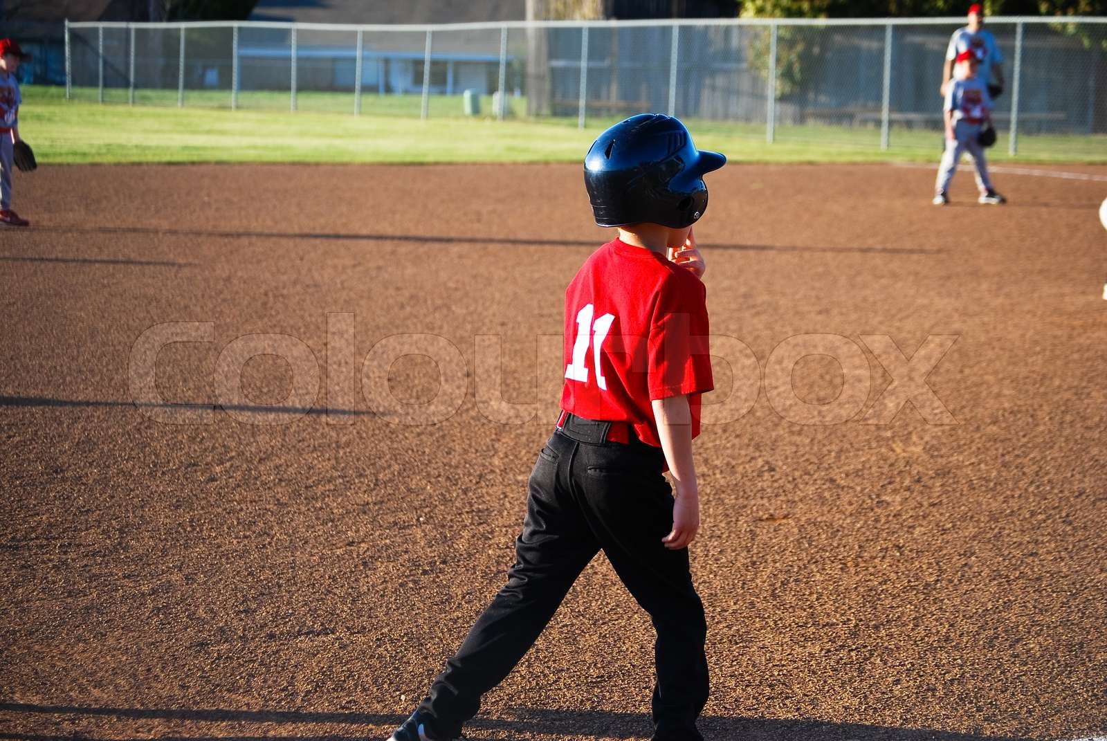 Baseball boy on third base | Stock image | Colourbox