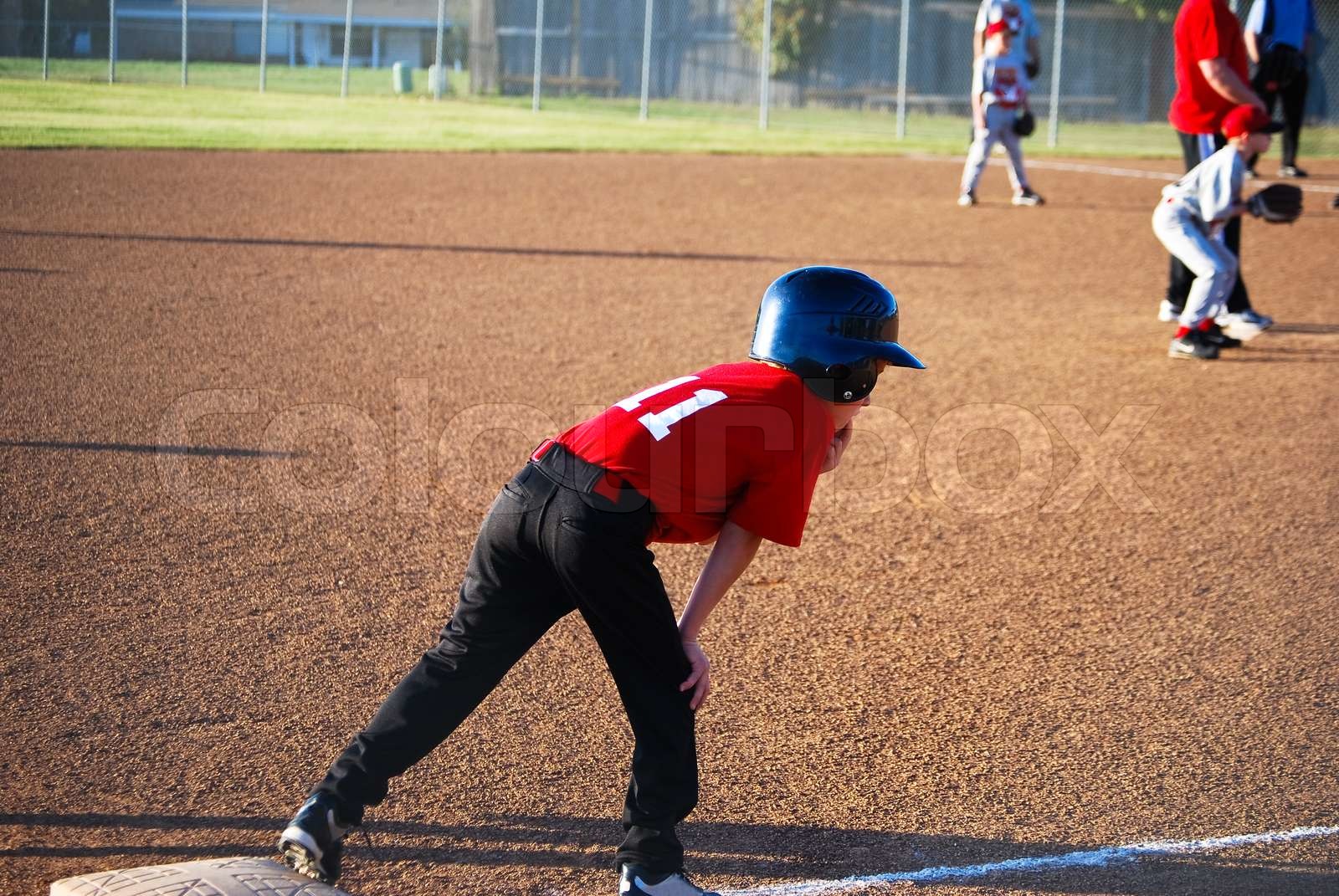 Baseball boy on third base | Stock image | Colourbox