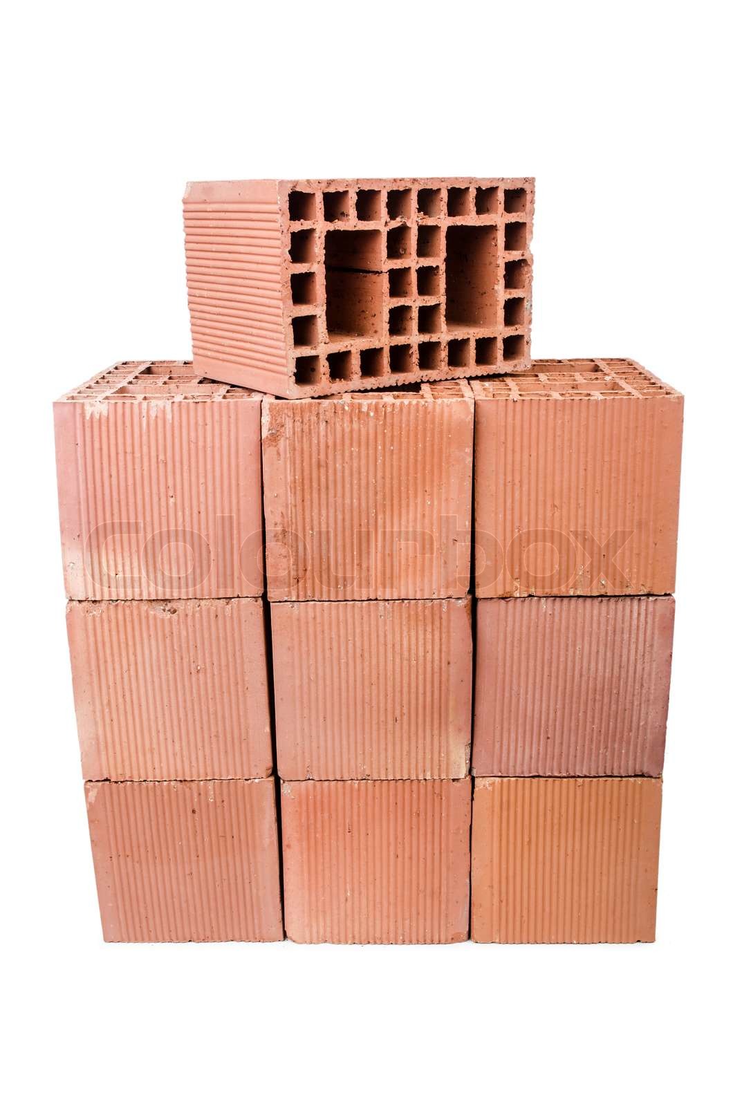 Stack of clay bricks isolated on white | Stock image | Colourbox