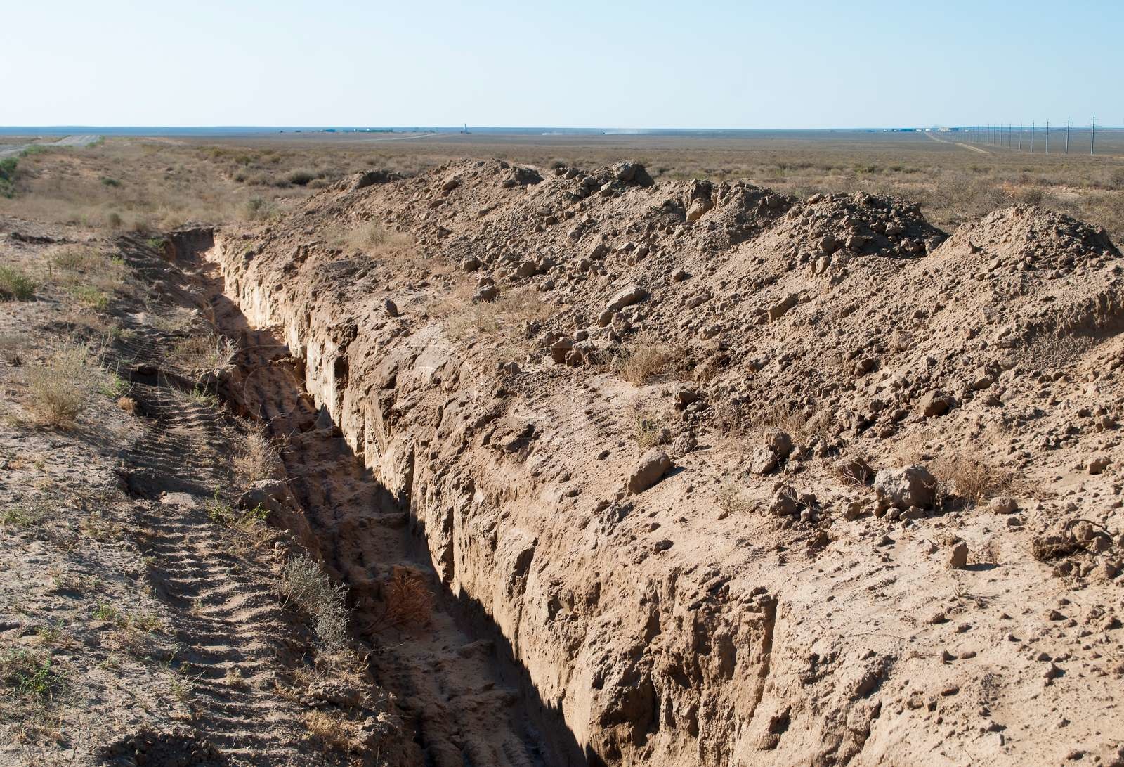 Long earthen trench dug to lay pipe | Stock image | Colourbox