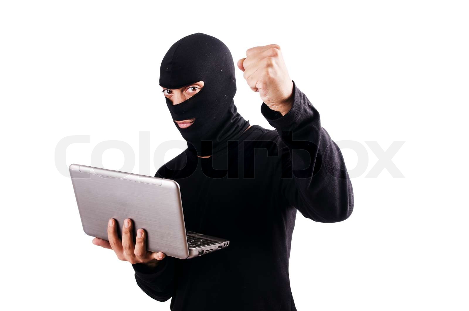 Hacker with computer wearing balaclava | Stock image | Colourbox