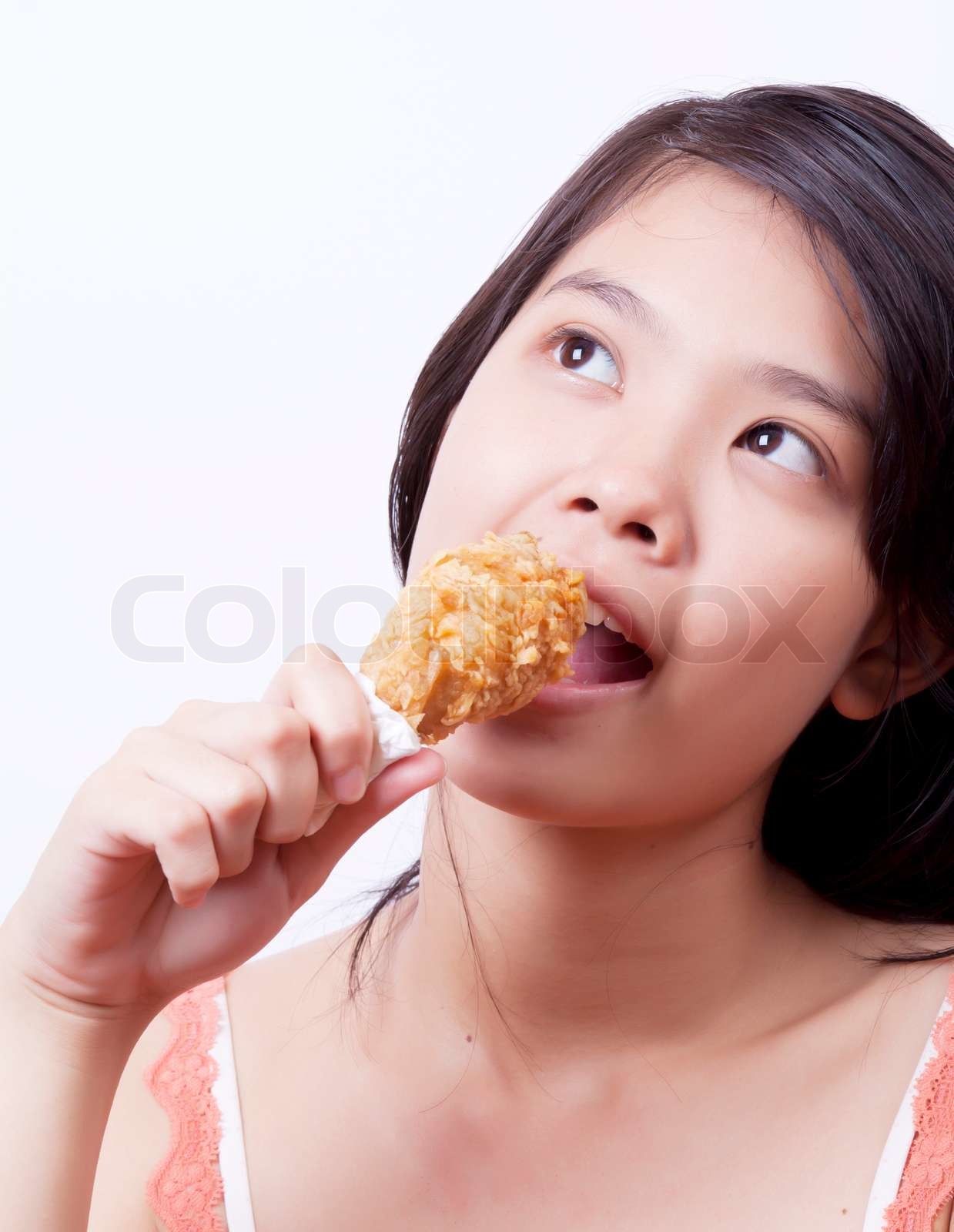 Asian girls eating fried chicken | Stock image | Colourbox