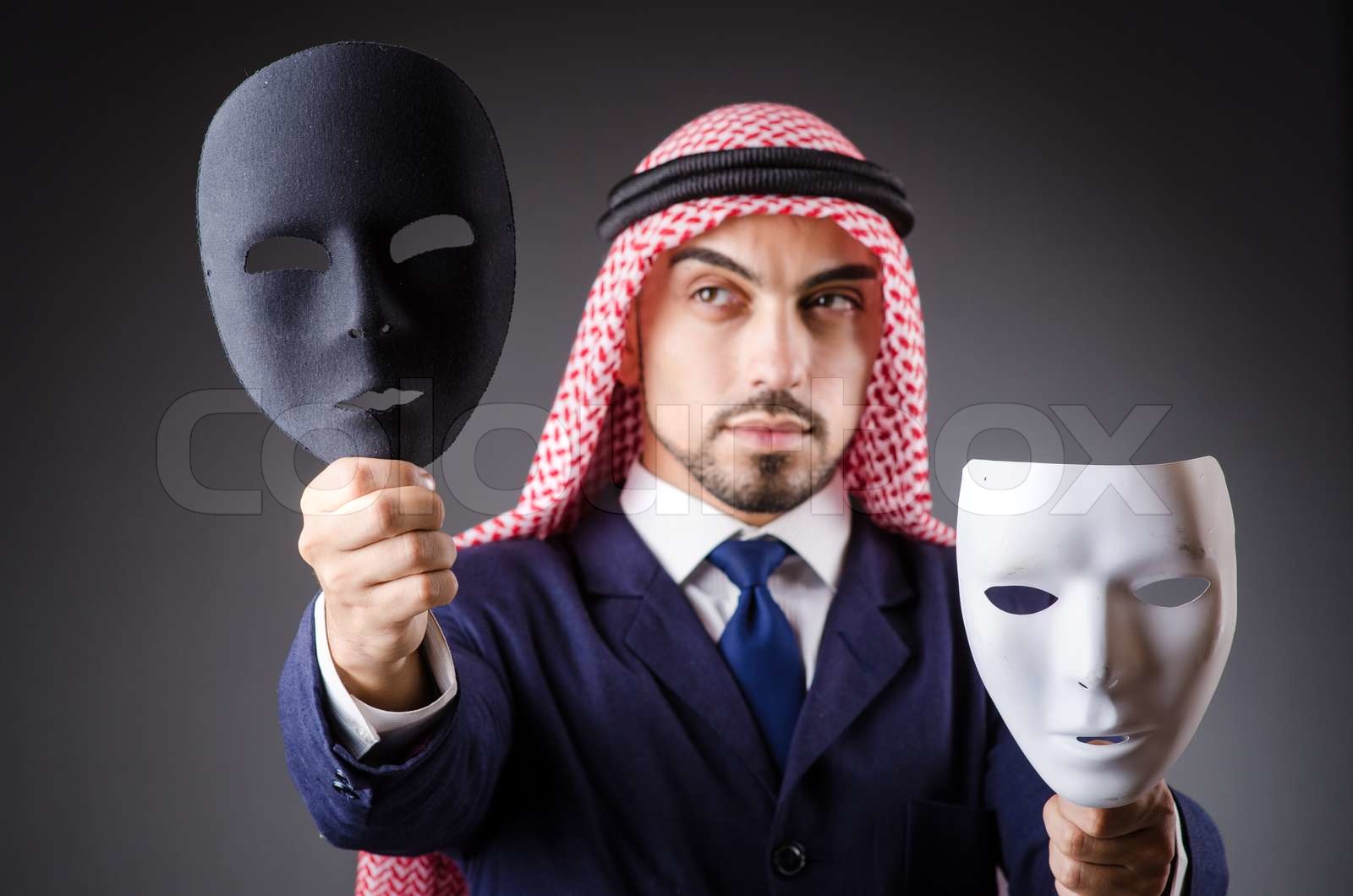 Arab with masks in dark studio | Stock image | Colourbox
