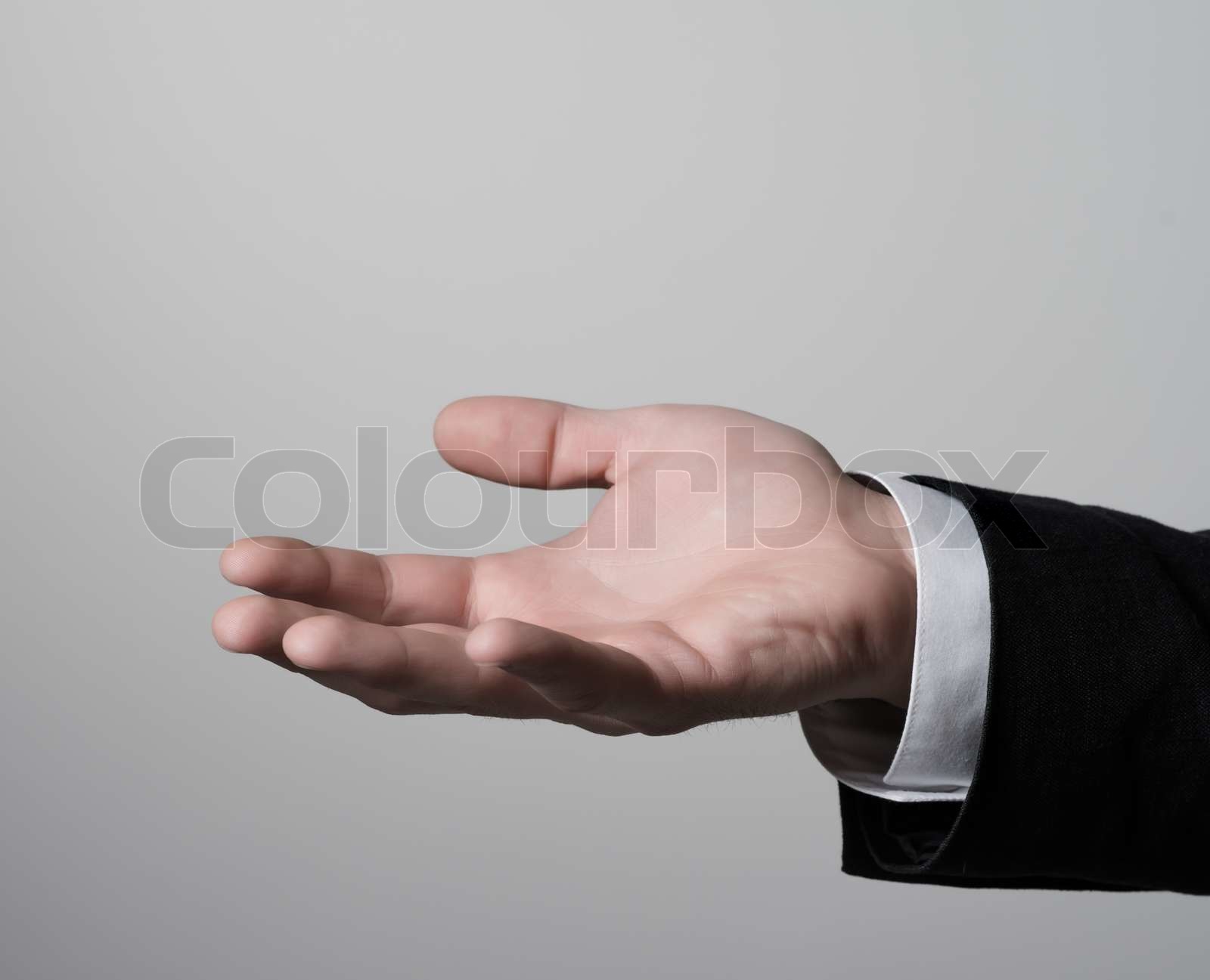 Mann hält etwas in der Hand | Stock Bild | Colourbox