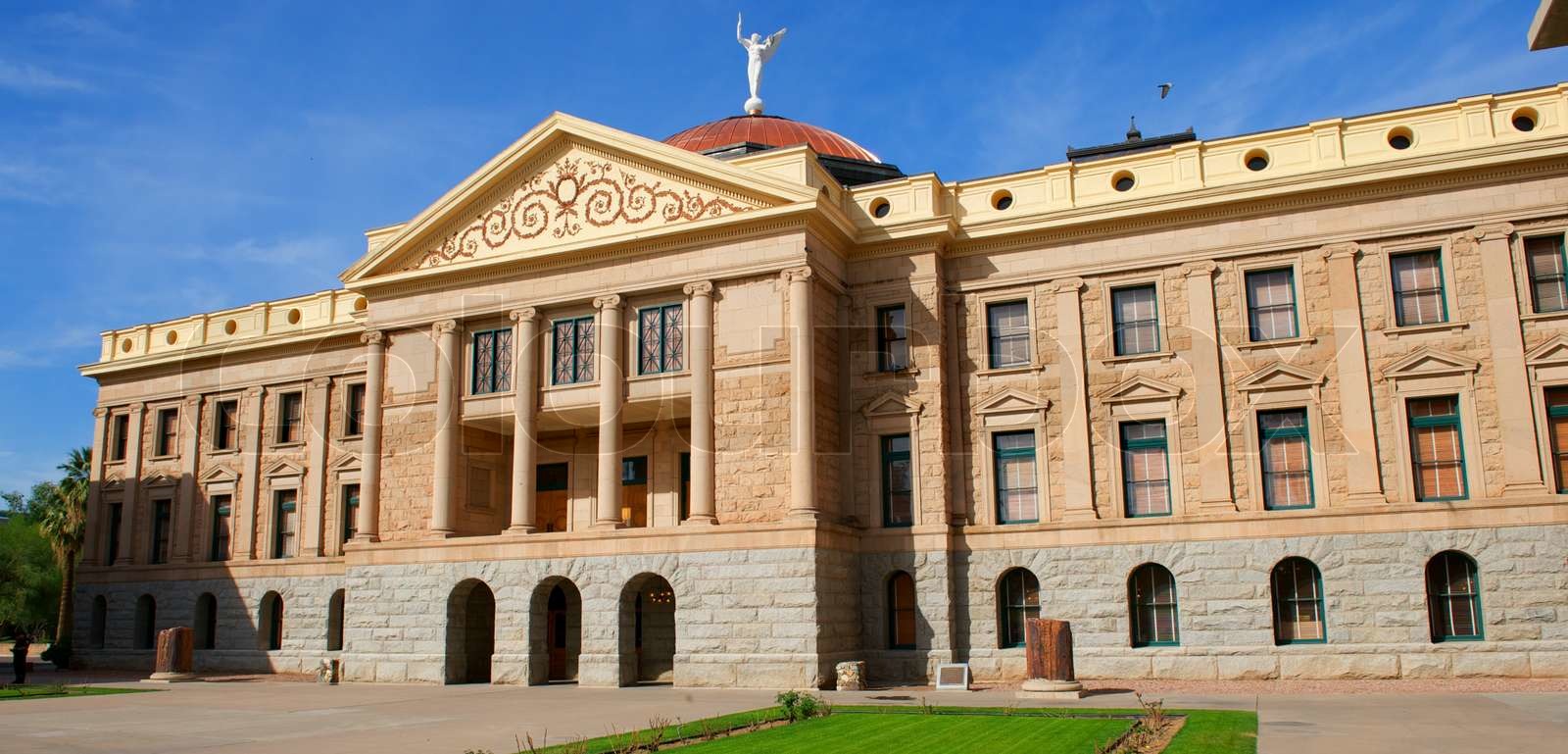 Arizona State Capital with windows, pillars, bright blue sky and green ...