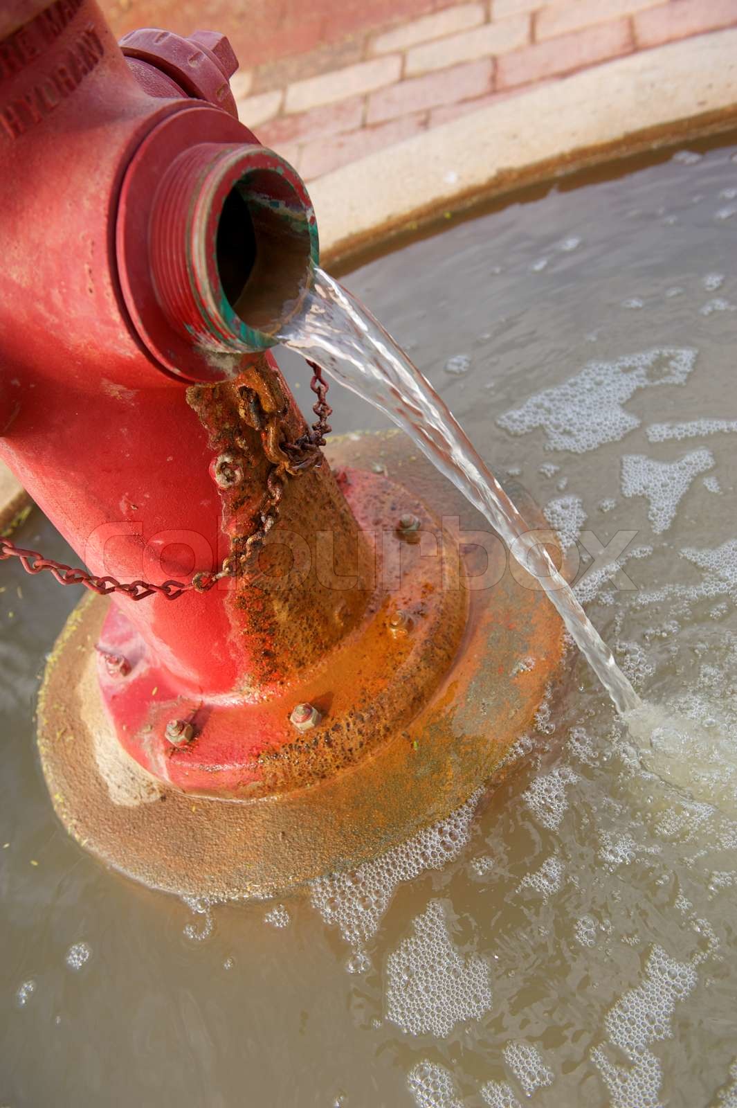 Red Fire Hydrant with Running Water pouring out | Stock image | Colourbox
