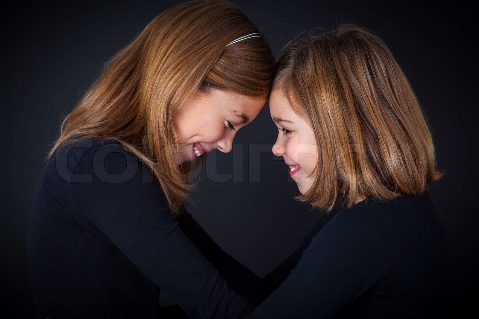 Portrait of friends touching face to face | Stock image | Colourbox