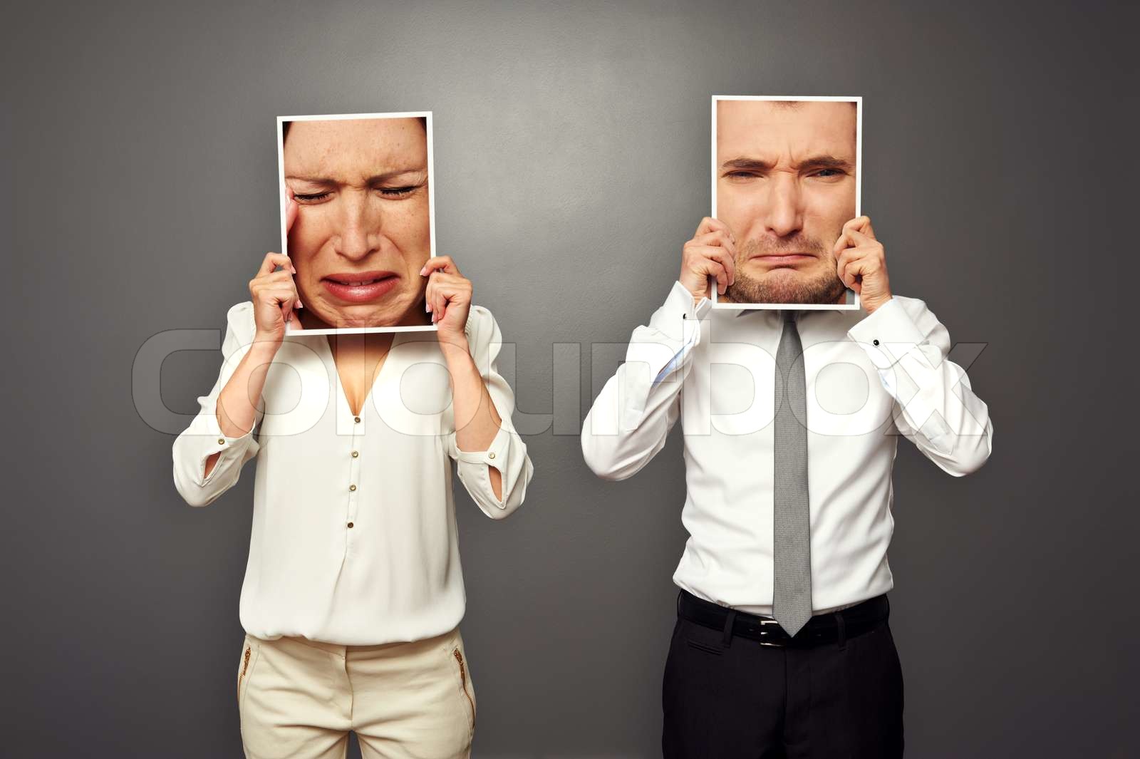 man and woman holding frames with sad faces | Stock image | Colourbox