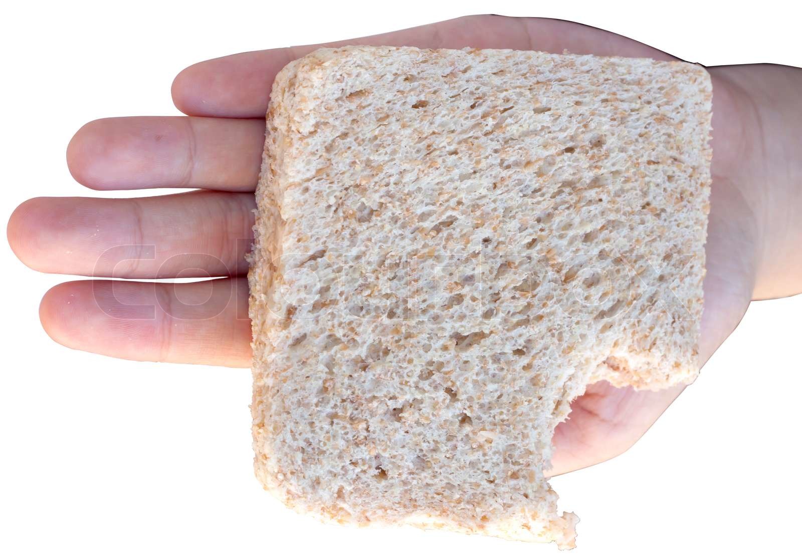 Brotscheibe auf der Hand auf weißem Hintergrund | Stock Bild | Colourbox