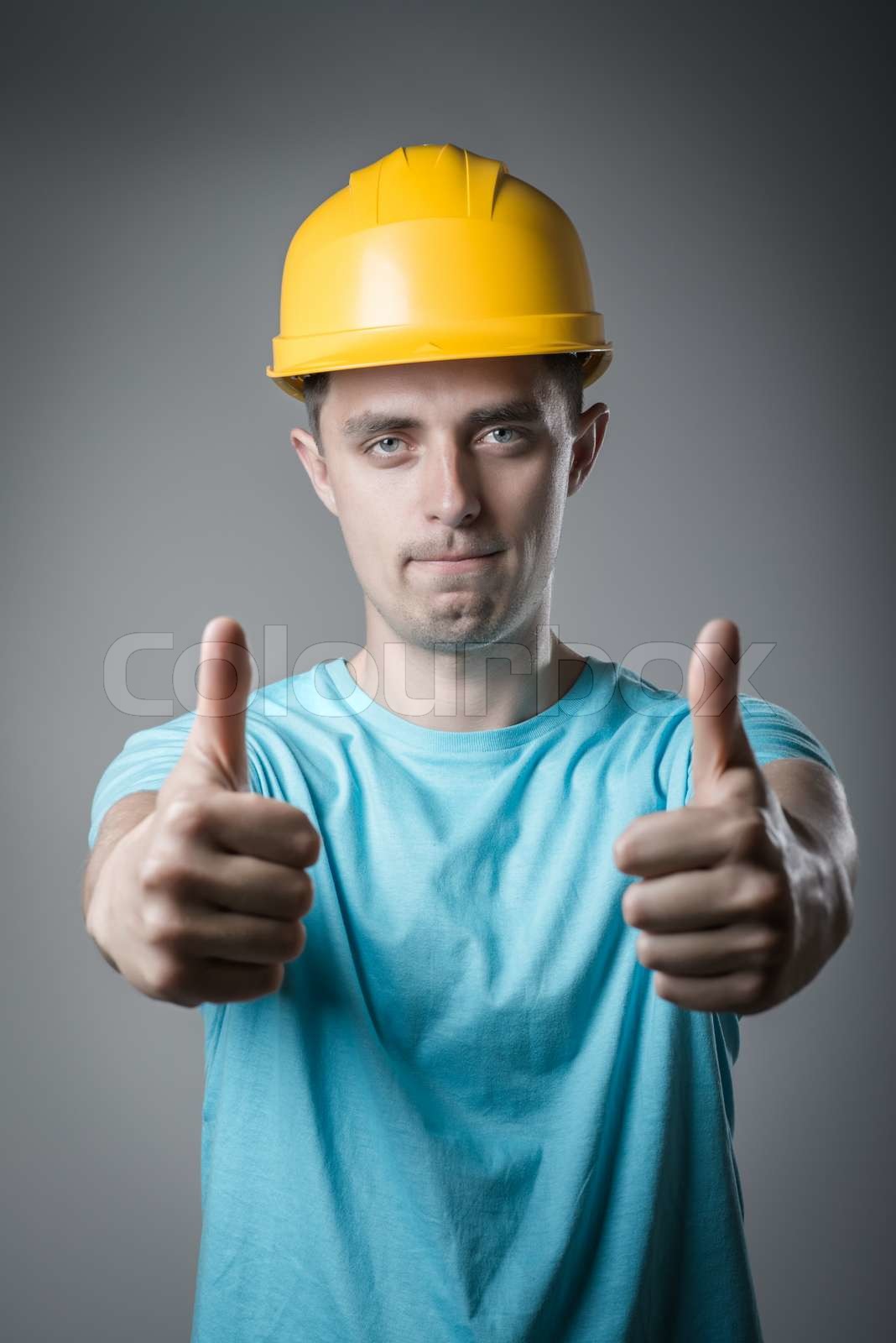 Arbeiter in Helm Daumen nach oben | Stock Bild | Colourbox