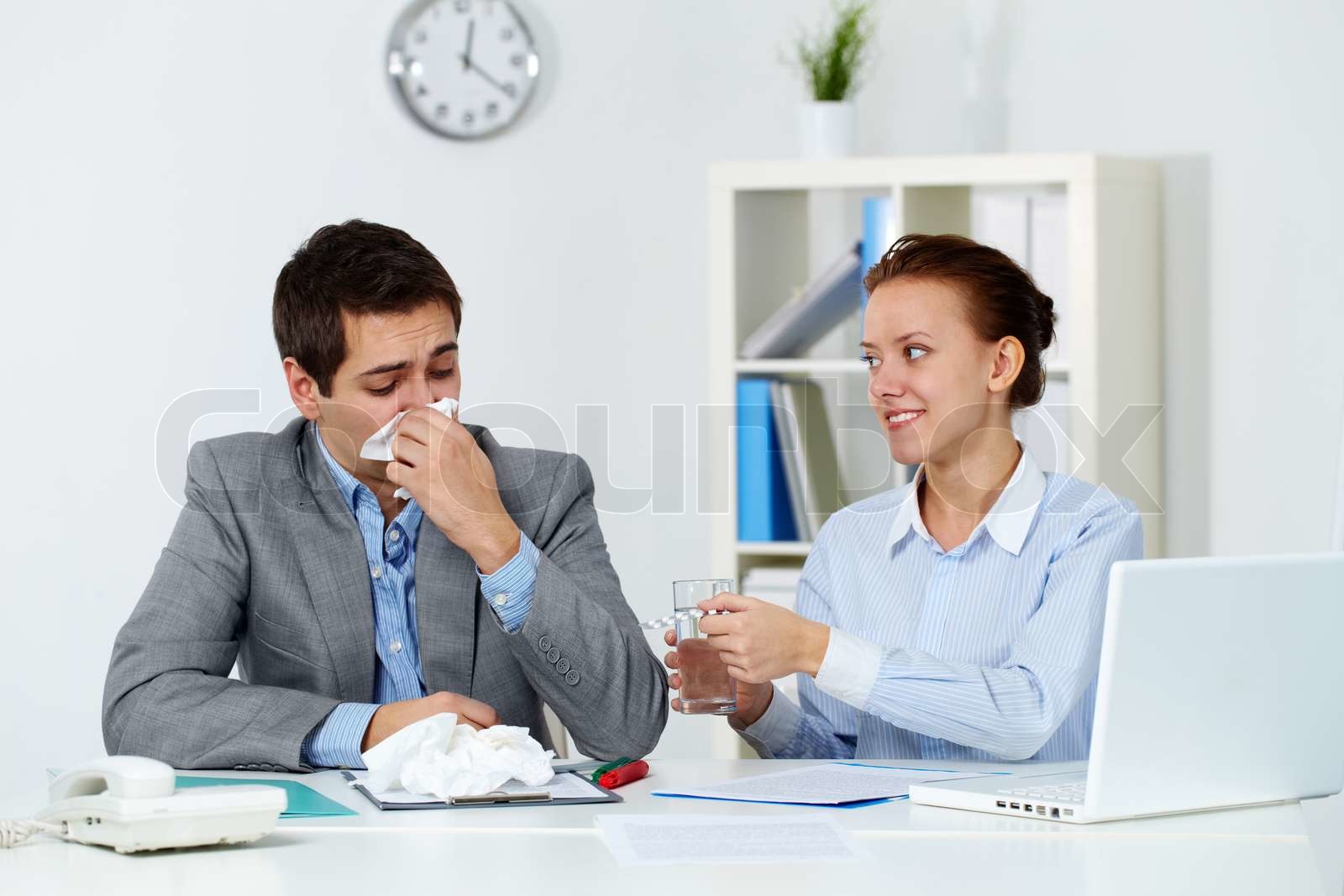 Taking care of sick co-worker | Stock image | Colourbox