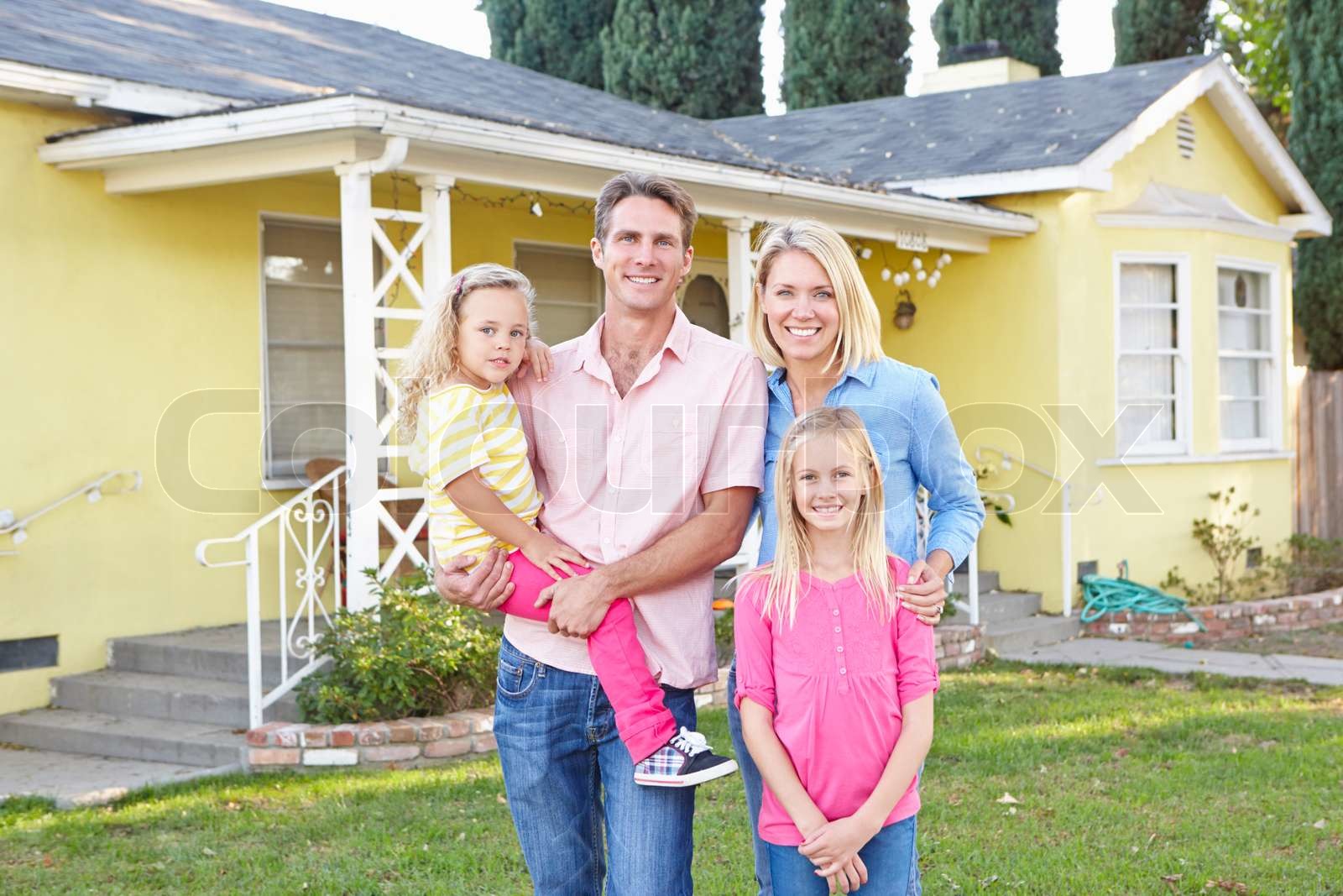 Family Standing Outside Suburban Home | Stock image | Colourbox