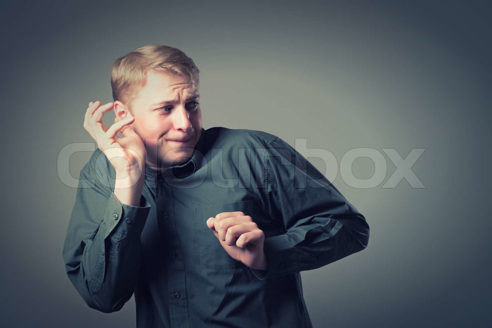 Scared man reaching up | Stock image | Colourbox